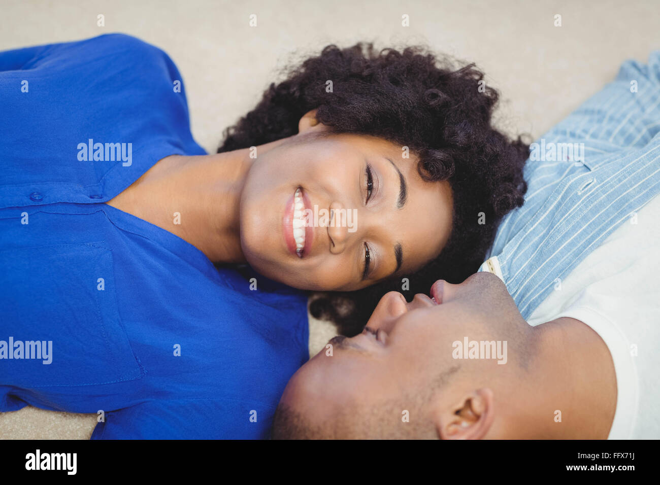 Peaceful couple lying on the floor Stock Photo - Alamy