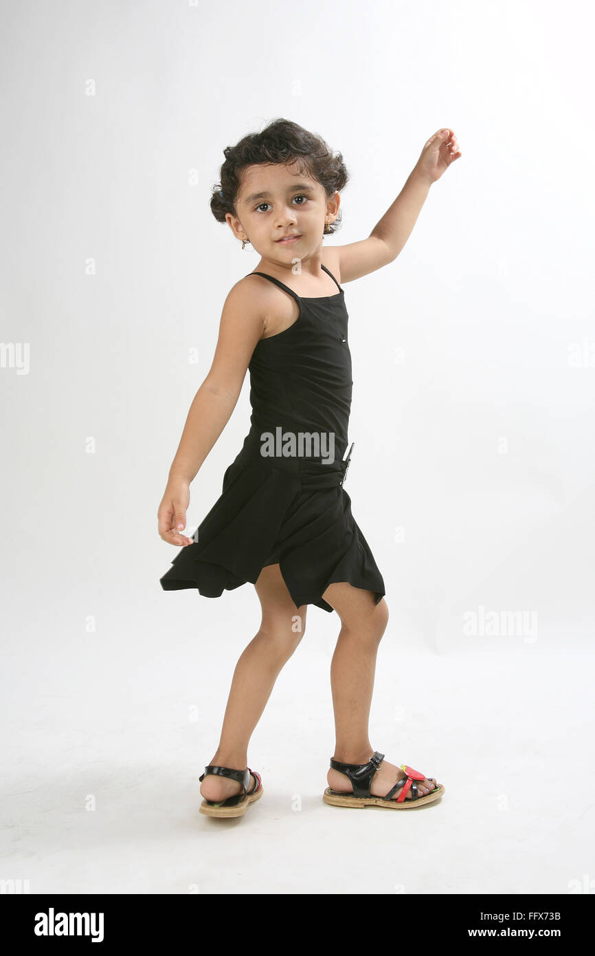 young girl of 4 years playful mood dancing turning around herself round ...