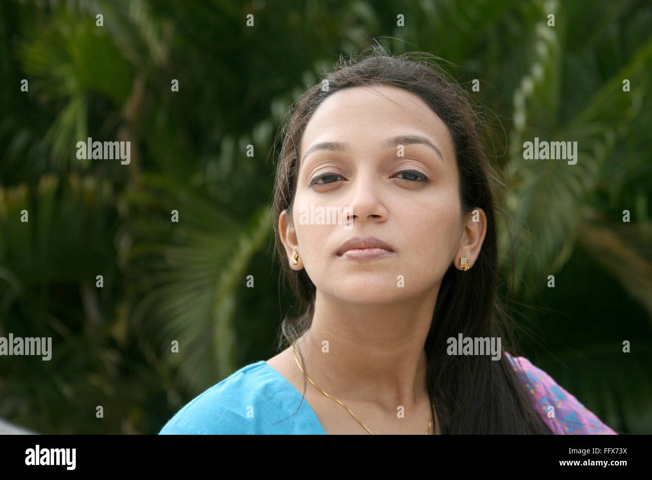 young lady lifting her one hand with fist and expressing winning ...