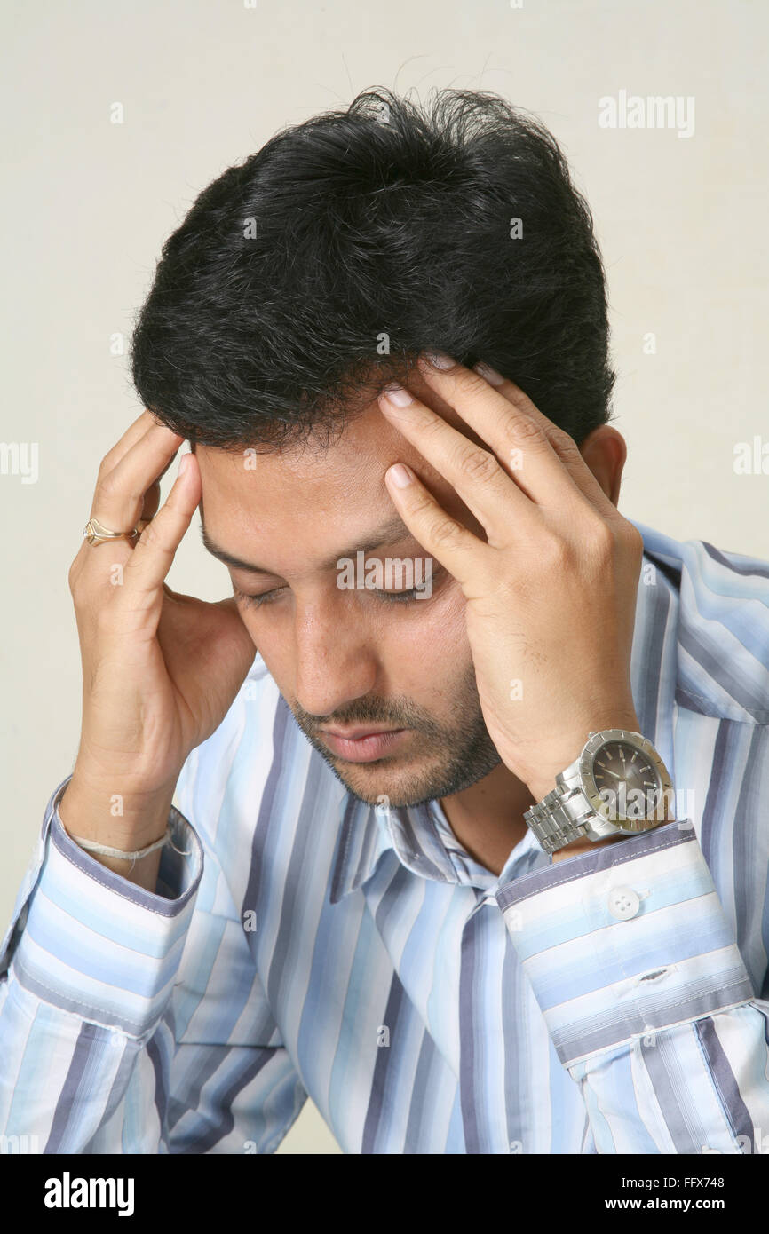 young man touching his head with both hands and thinking MR # 687 I ...