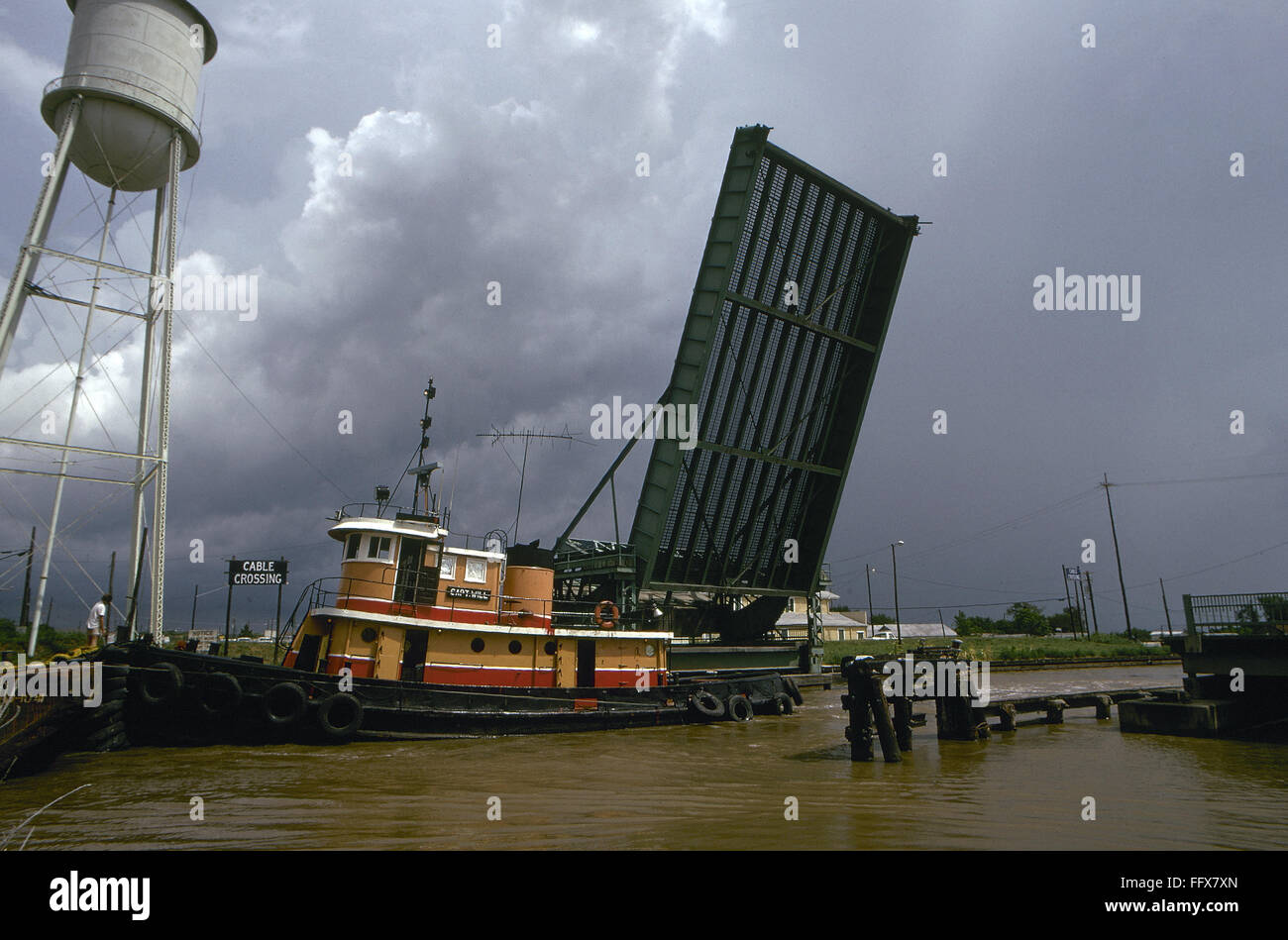 MISSISSIPPI RIVER DELTA. /nA tugboat going under a drawbridge in the ...