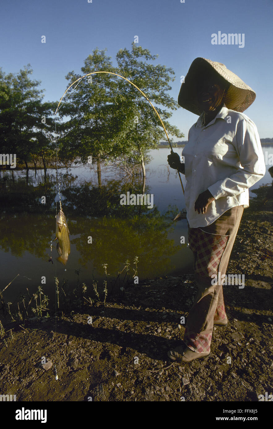 MISSOURI: FISHING. /nA woman displaying her catch on the banks of the ...
