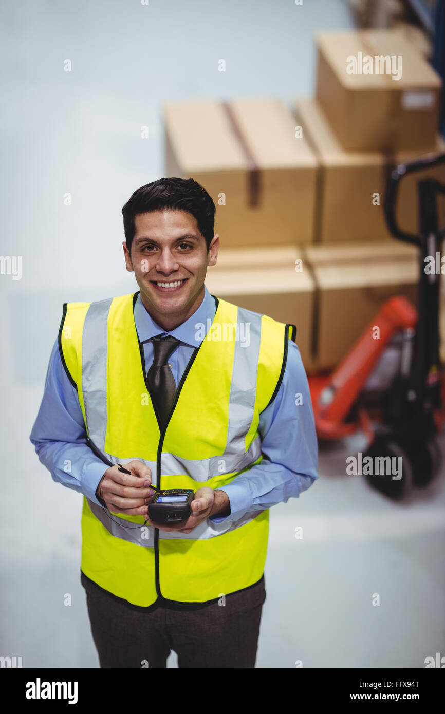 Warehouse worker using hand scanner Stock Photo - Alamy