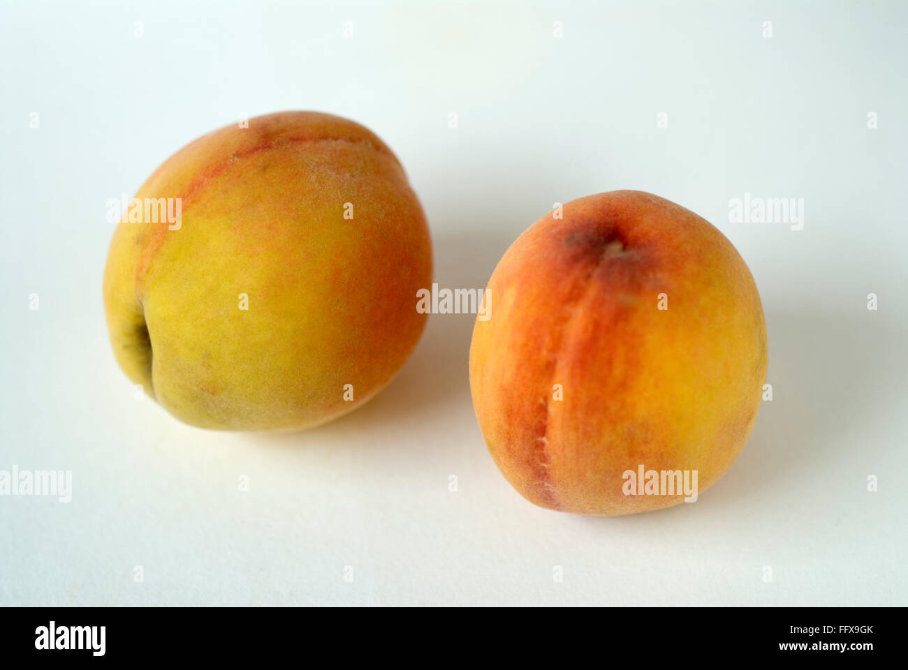 Few Peaches fruits in basket white background Stock Photo - Alamy