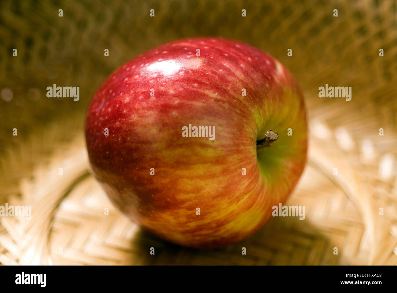 Apple round red fruit single in basket Stock Photo - Alamy