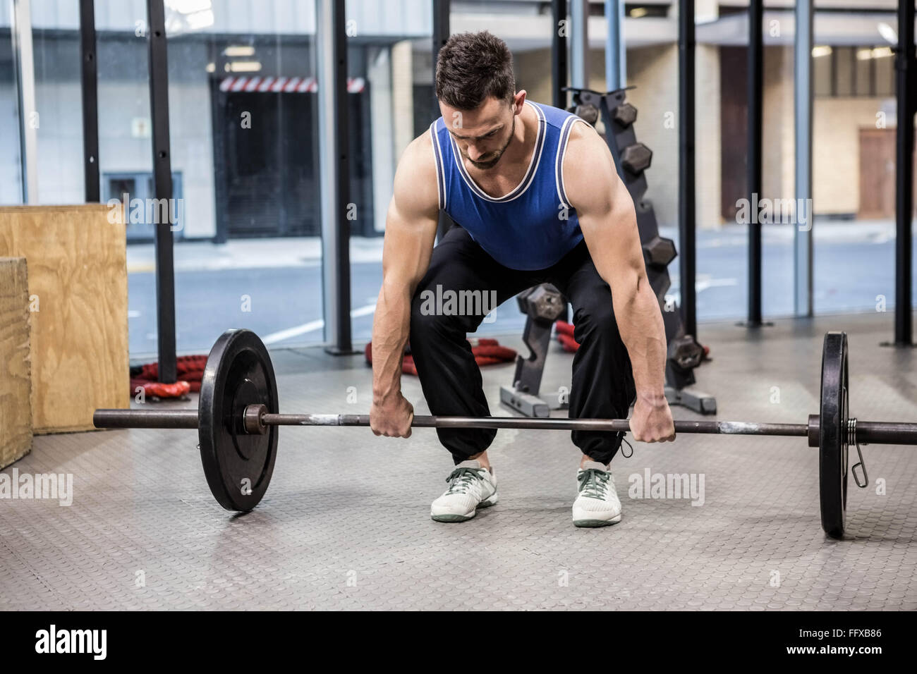 Muscular man lifting barbell Stock Photo - Alamy