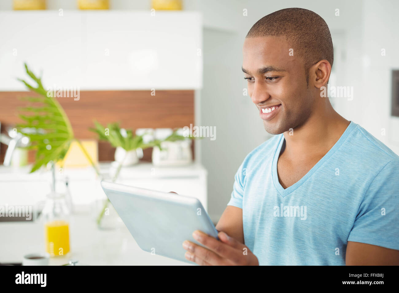 Handsome man using tablet Stock Photo - Alamy