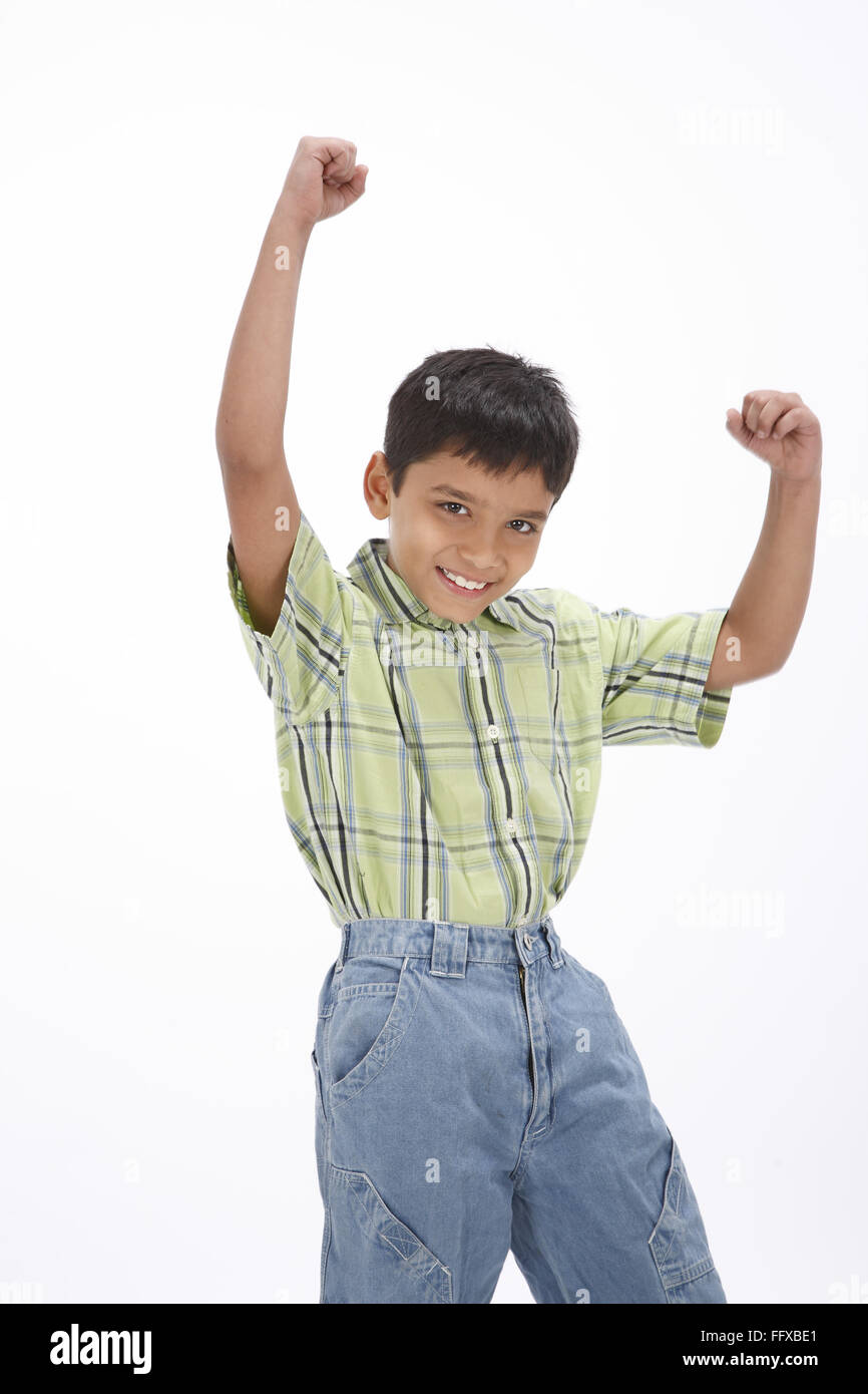 Ten years old boy doing winning action enjoying success by making fist ...