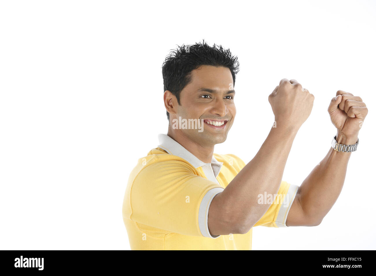 Confident young man doing winning action enjoying success by making ...