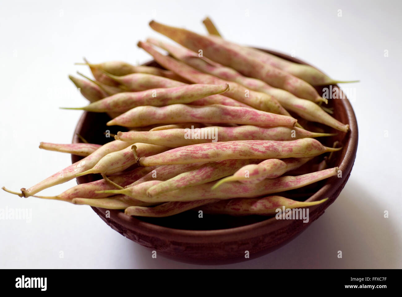 Rajma beans in round wooden bowl pods cream and dark pink legume ...