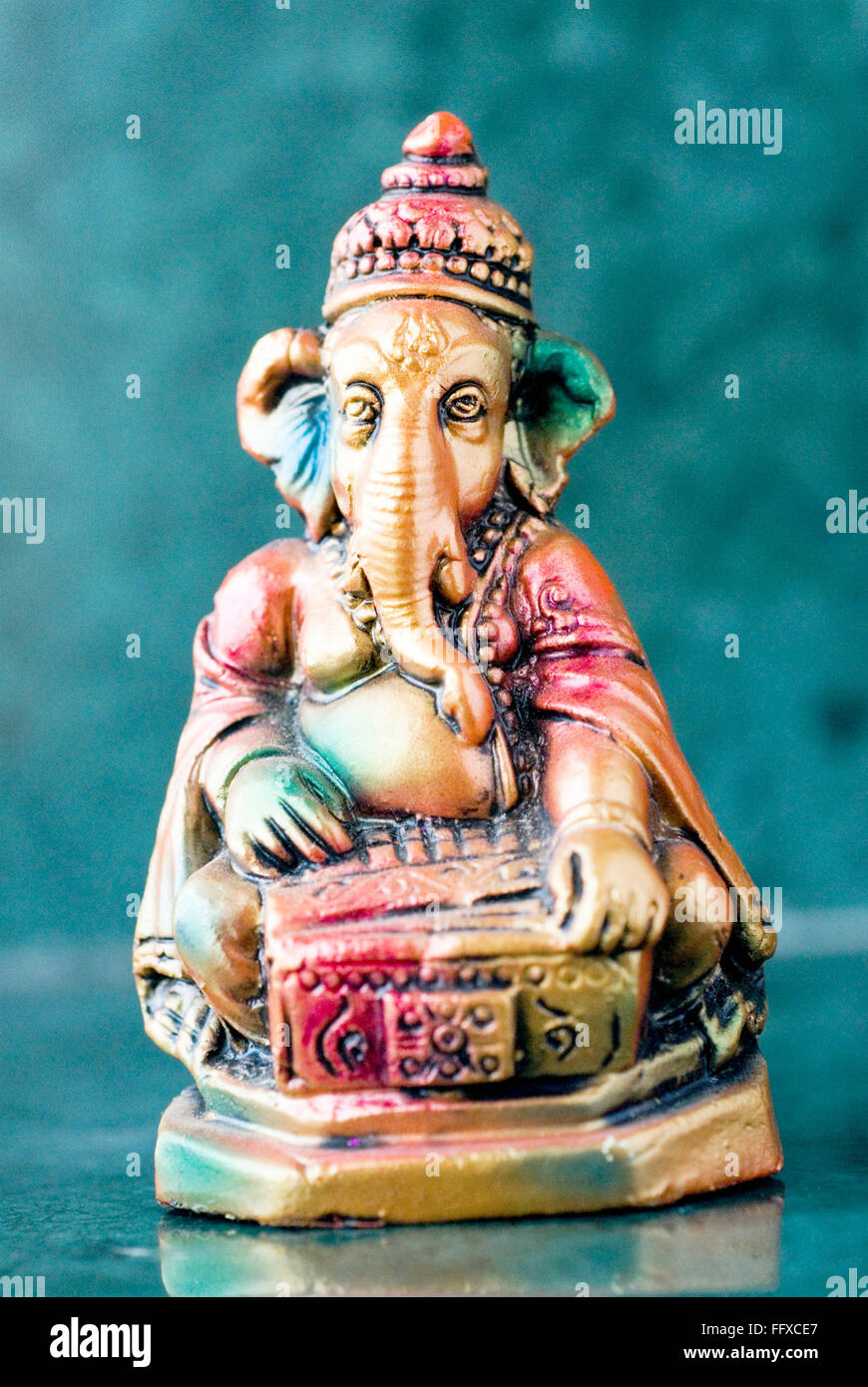 Lord Ganesha ganpati plaster Idol sitting colourful playing harmonium ...