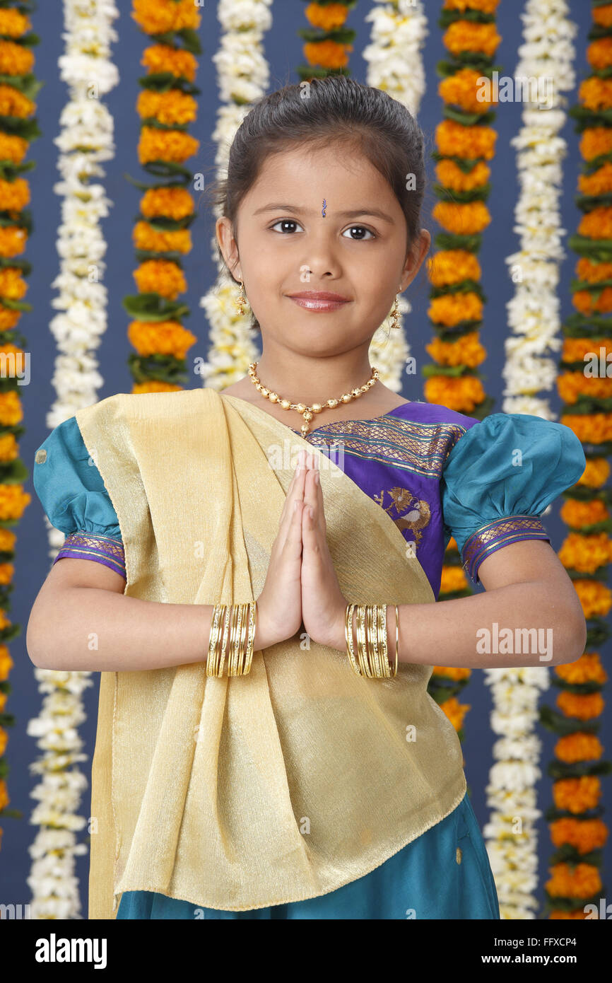 Girl joining both hand palms doing Namaste MR#703N Stock Photo - Alamy