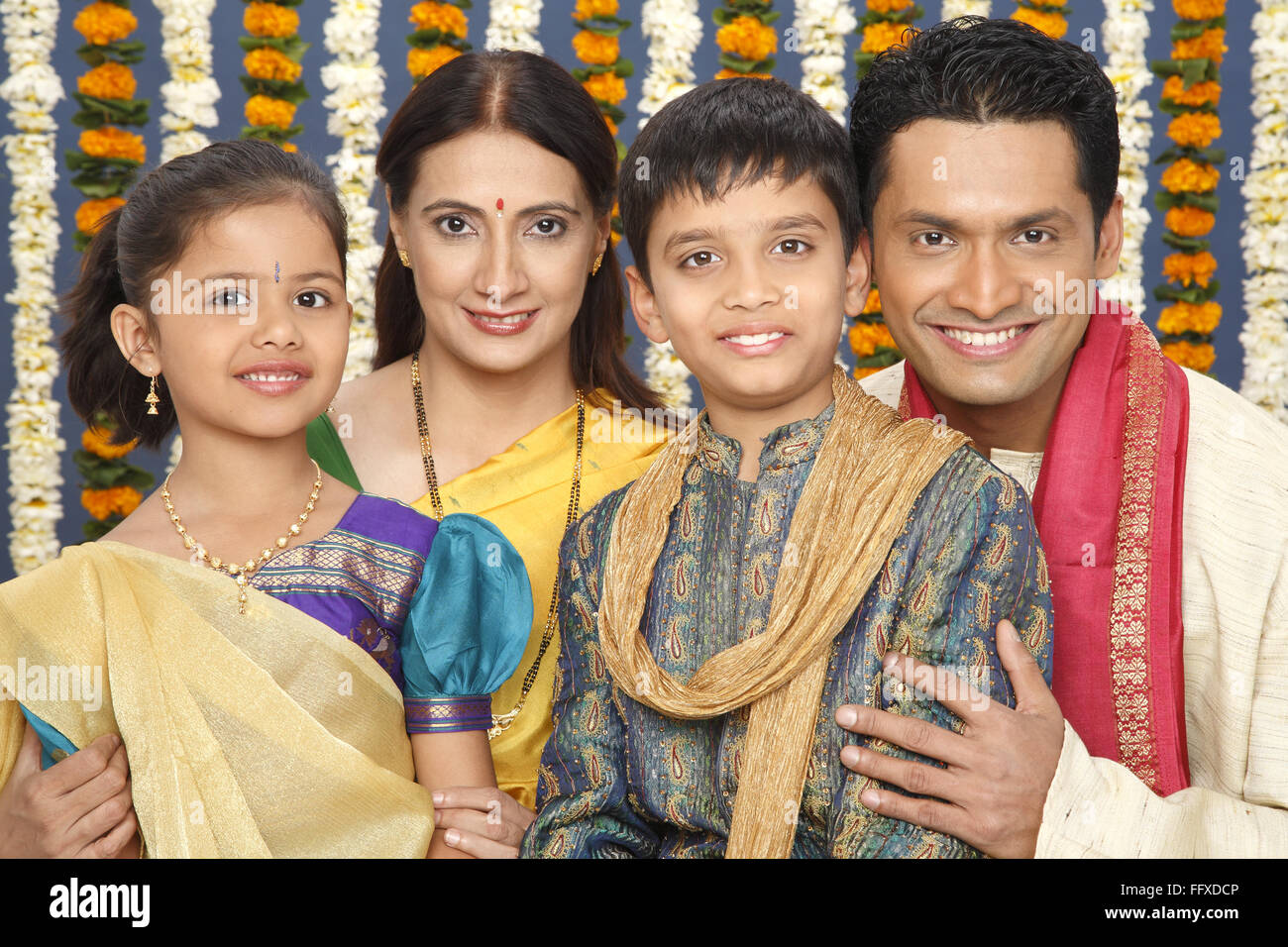 Parent with children in traditional wearing sitting together MR#703N ...