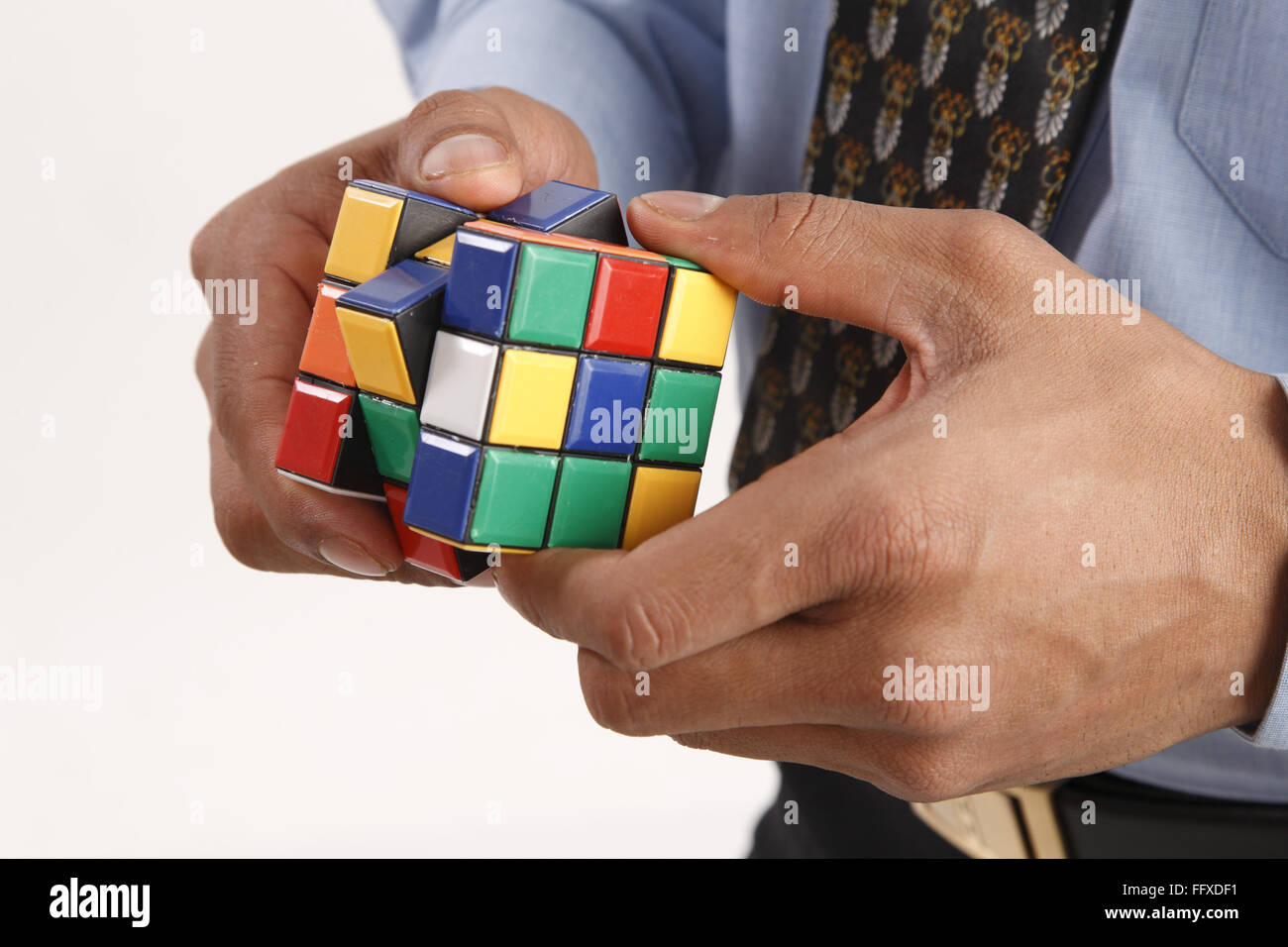 Businessman hand holding Rubik cube in both hands and trying to solve puzzle Model Release ...