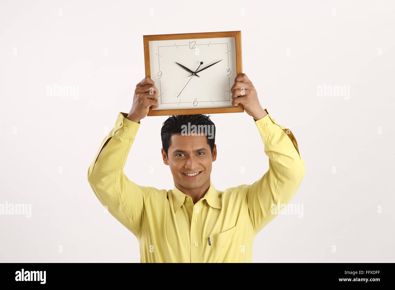 Businessman holding wall clock on his head with both hands MR#703T ...