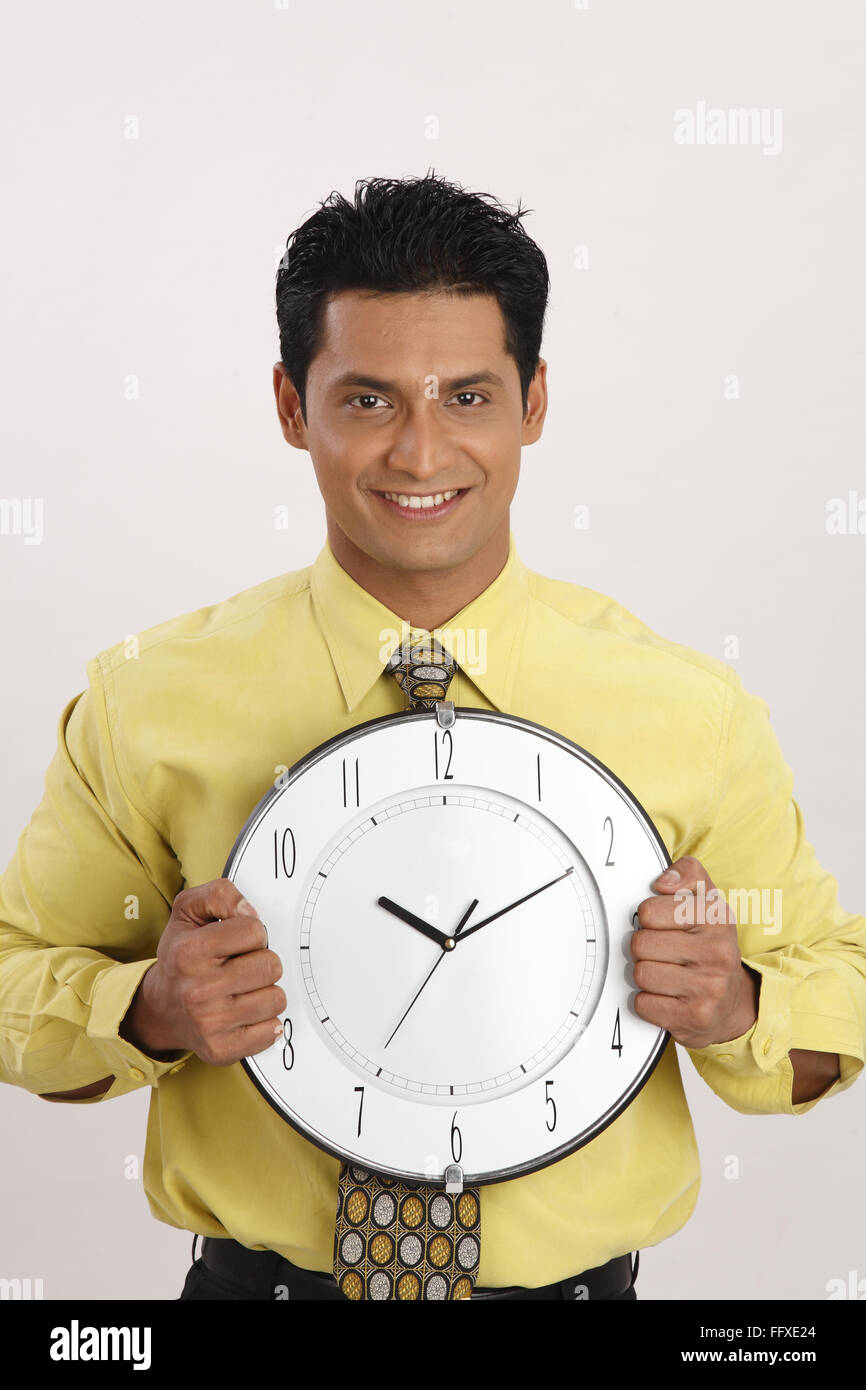 Businessman holding wall clock hi-res stock photography and images - Alamy