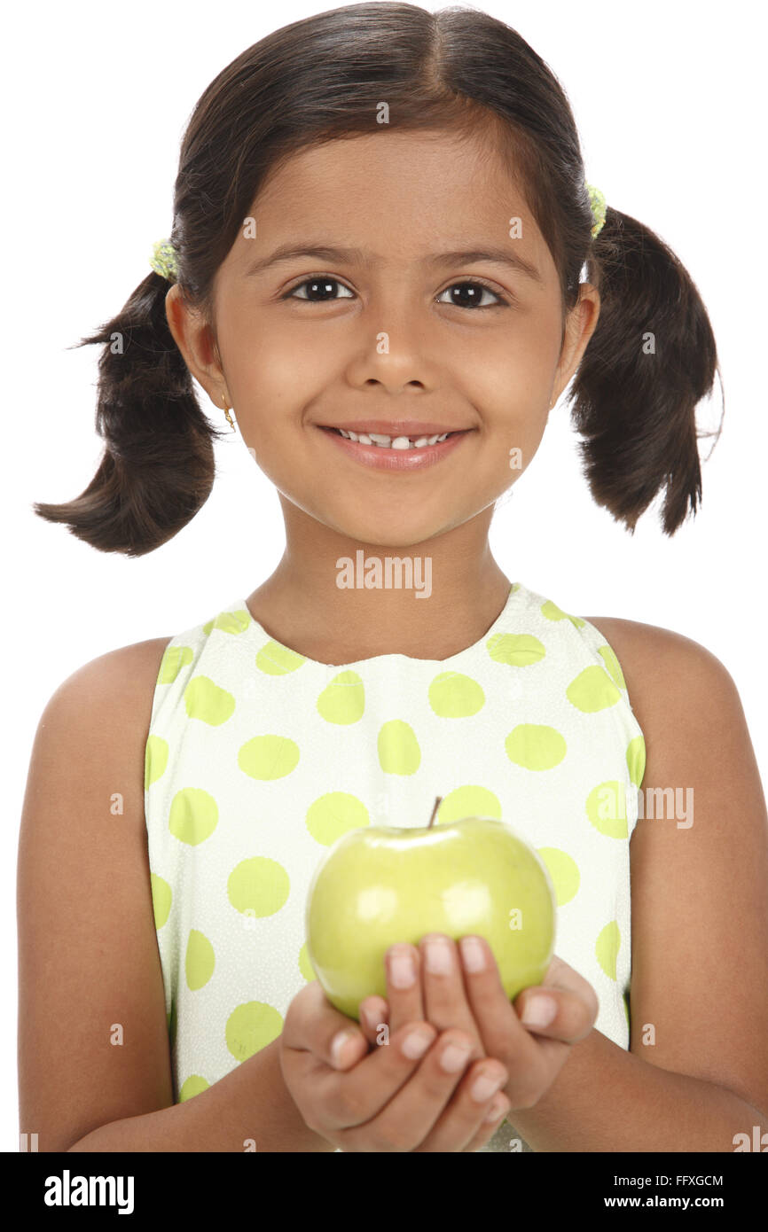 Eight year old girl holding green apple in both hands MR#703U Stock ...