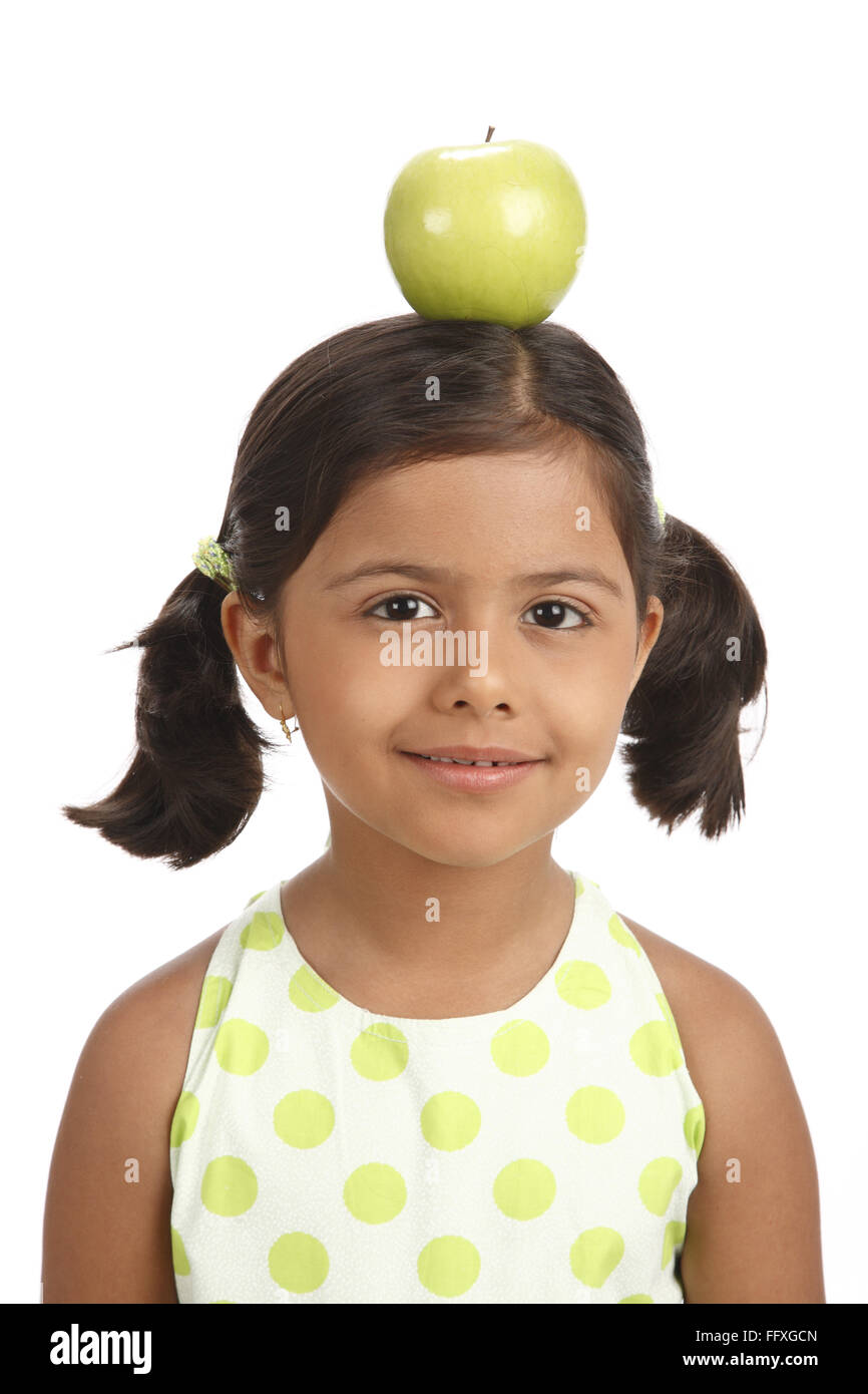 Eight year old girl kept green apple on head and balancing it MR#703U ...
