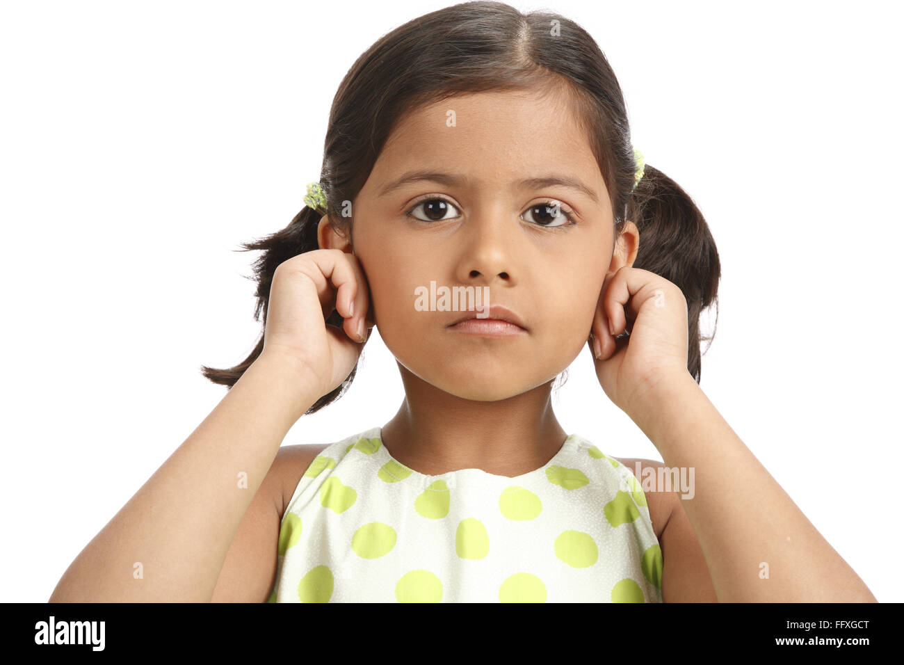 Eight year old girl holding both ears with both hands MR#703U Stock ...