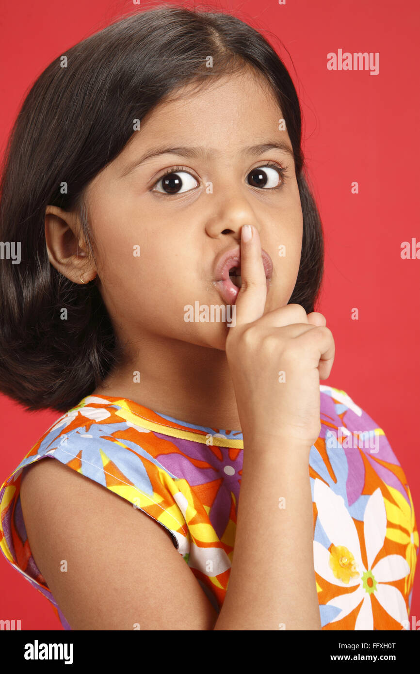 Eight year old girl kept her right hand index finger on lips MR#703U ...