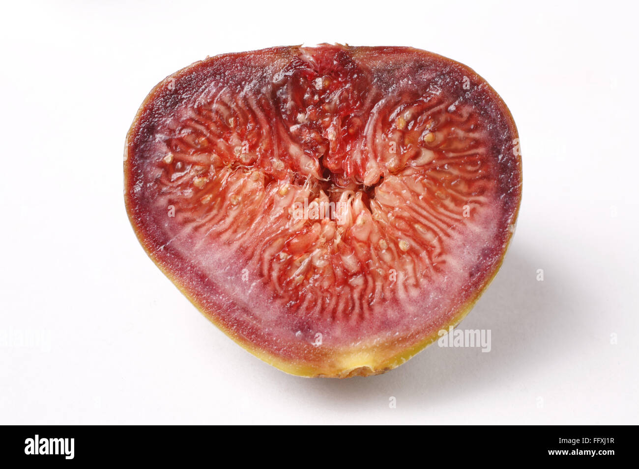 Fruit , Fig Ficus Carica Anjir half cut with red juicy texture on white ...