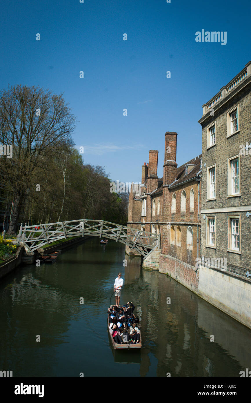 Student Punting tourists past the Mathematical Bridge on the River Cam ...