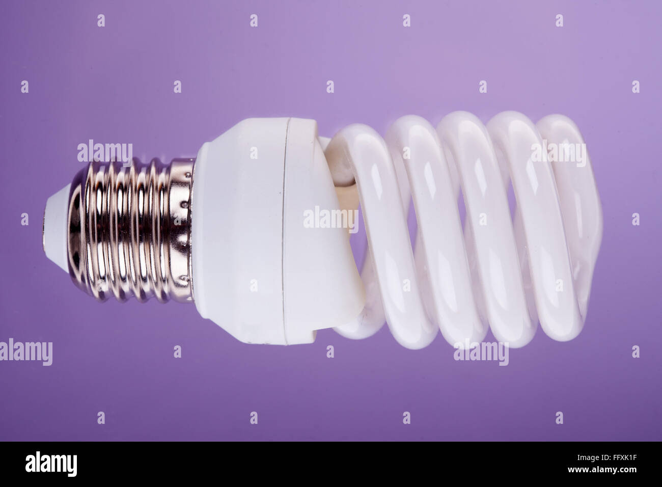 energy saving light bulb on blue closeup background Stock Photo - Alamy