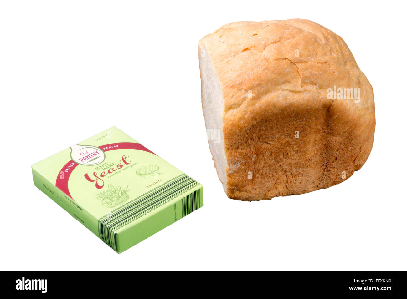 Home baked loaf of bread with a carton of powdered baking yeast sachets ...