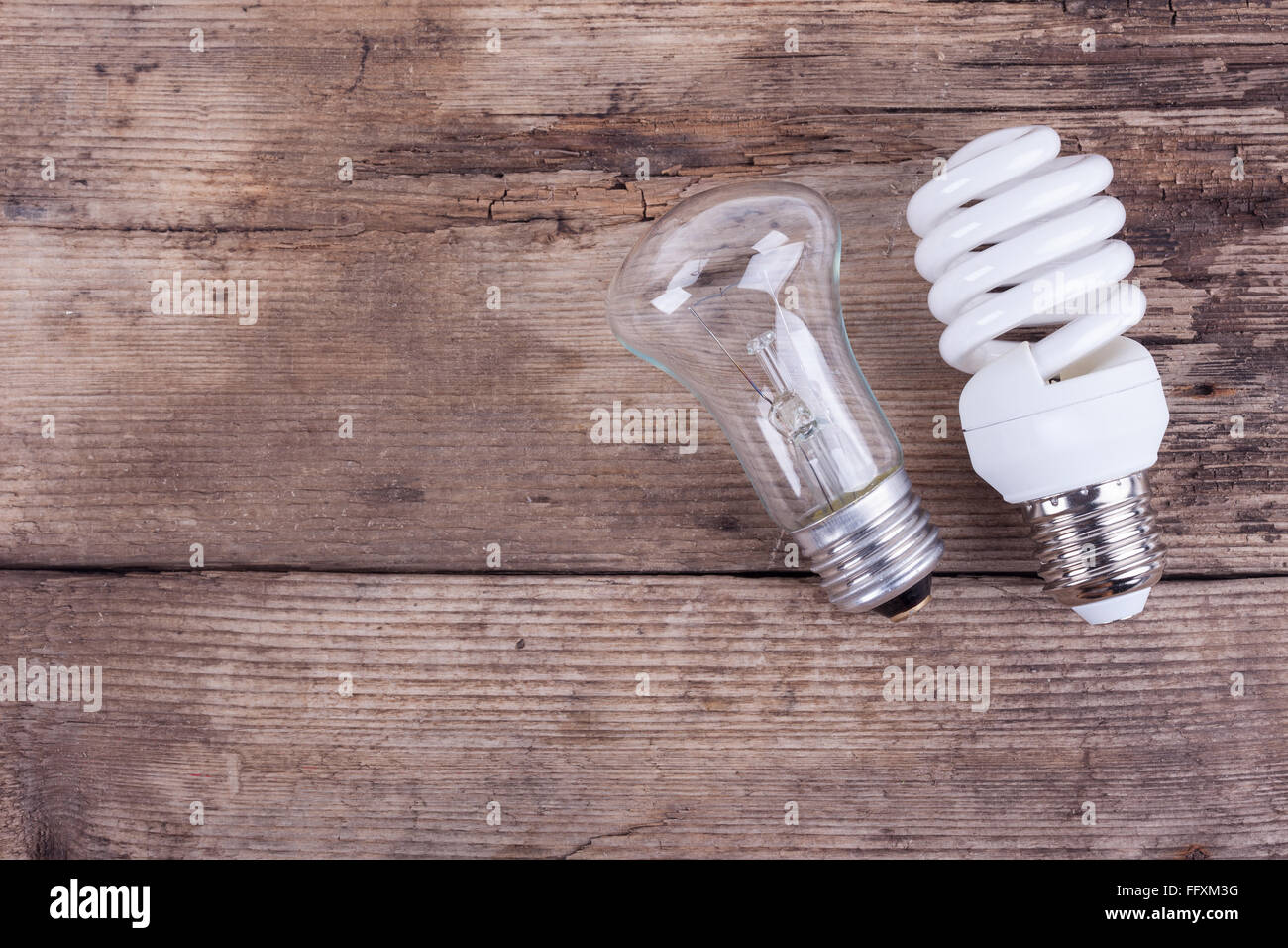 two types of light bulbs on wooden background Stock Photo - Alamy