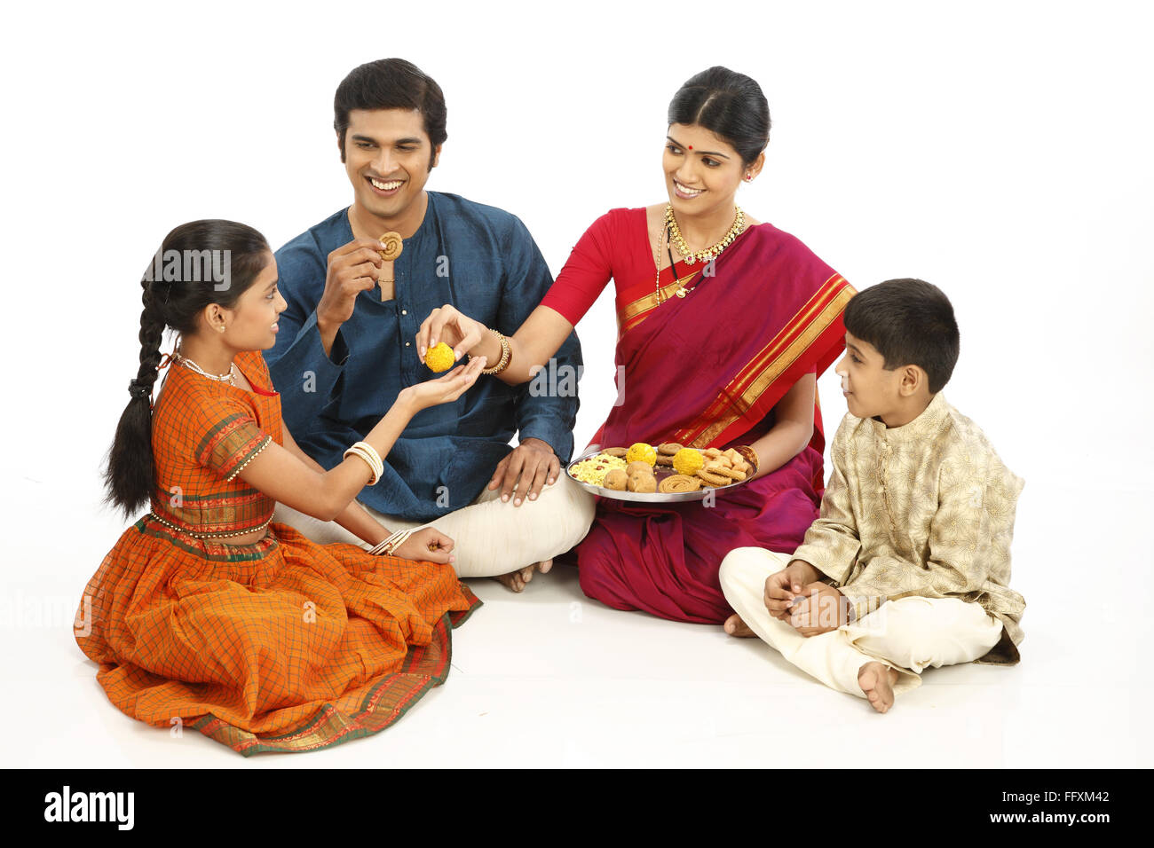 Rich rural farmer family sitting together mother serving snacks MR#743A ...