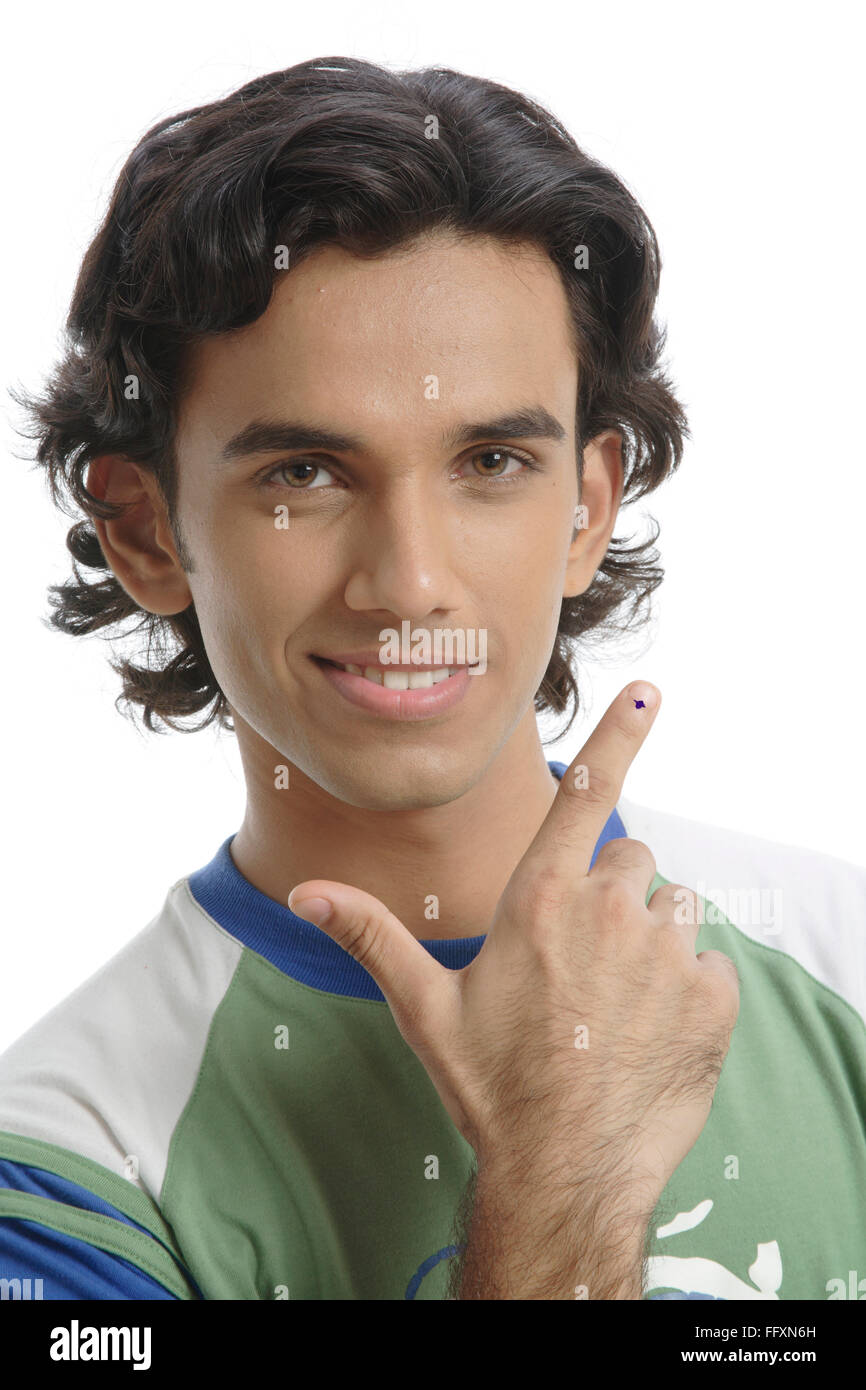 Teenage boy pointing thumb and index finger like gun shape showing ...