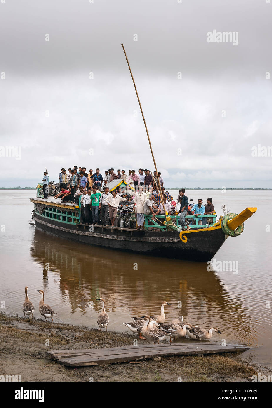 Overcrowded public ferry arrives at Nimati Ghat from Majuli Island ...