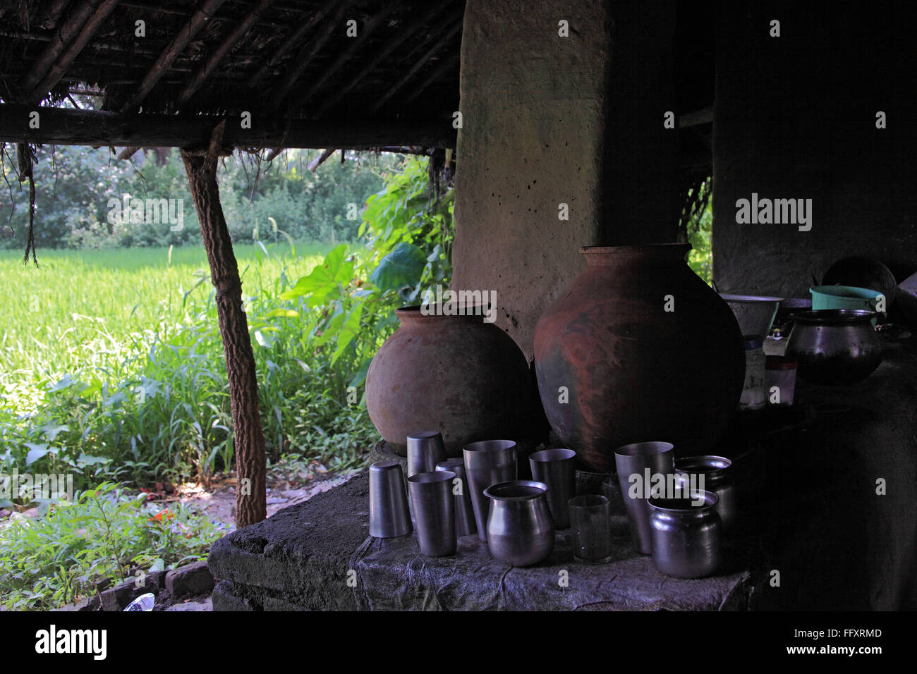 Drinking water in clay pot with stainless steel glasses at Orissa India ...
