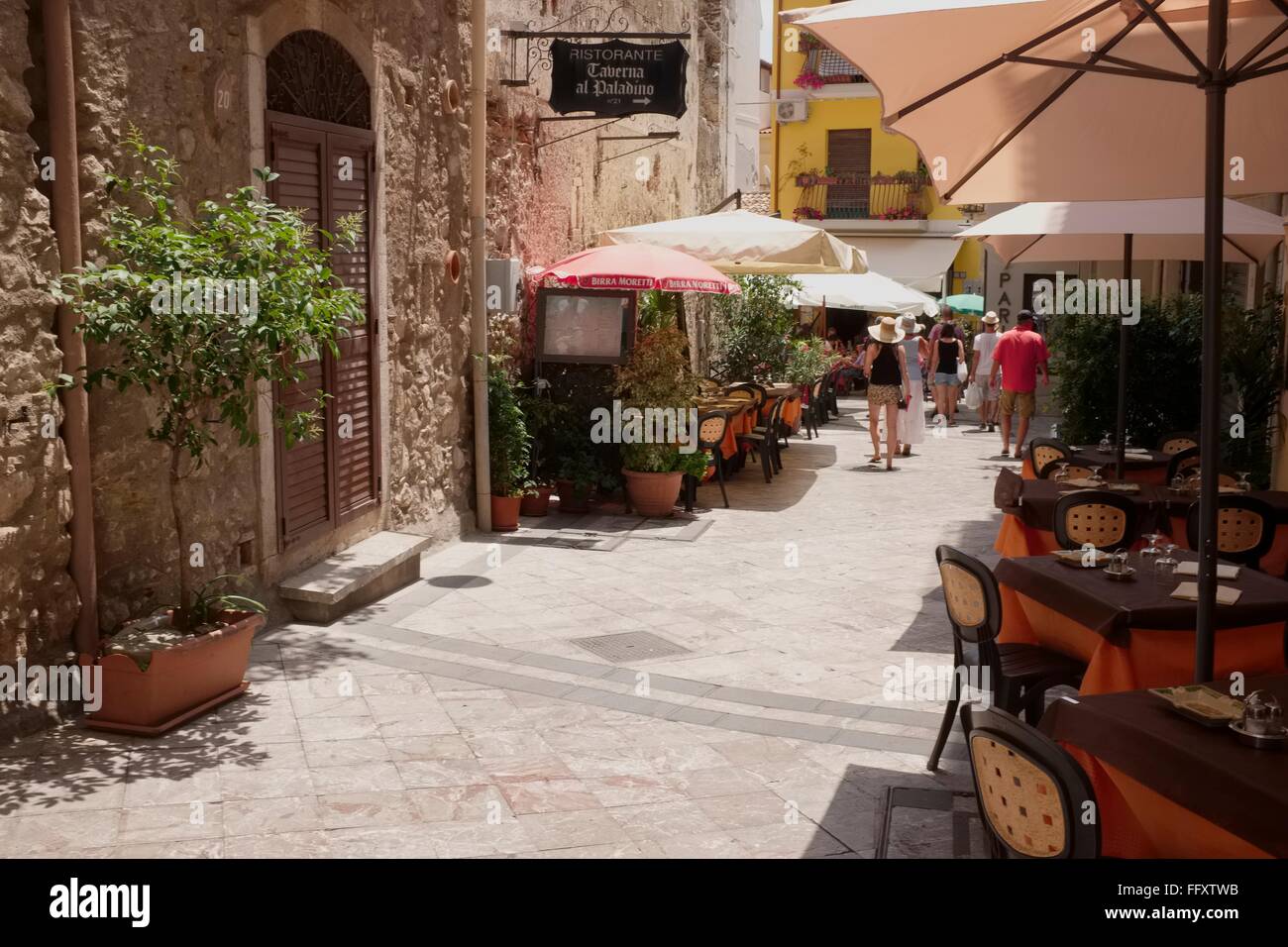 North Eastern Sicily: A typical narrow restaurant lined street in ...