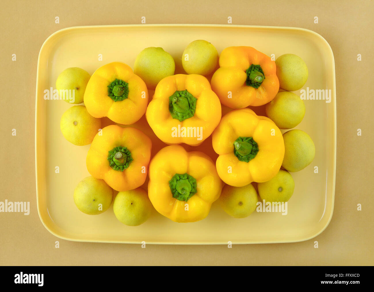Spices and fruit , yellow capsicum and lemons in tray Stock Photo - Alamy