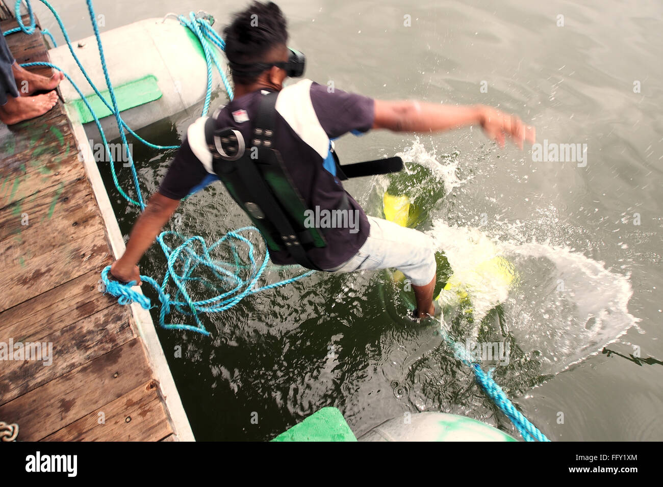 Underwater logging A diver is getting ready to go down, using the diver ...