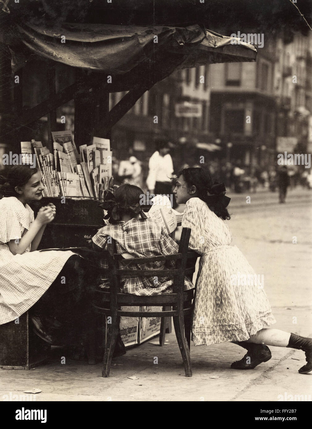 NEWSPAPER VENDORS, 1910. /nThree young girls working at a newspaper ...