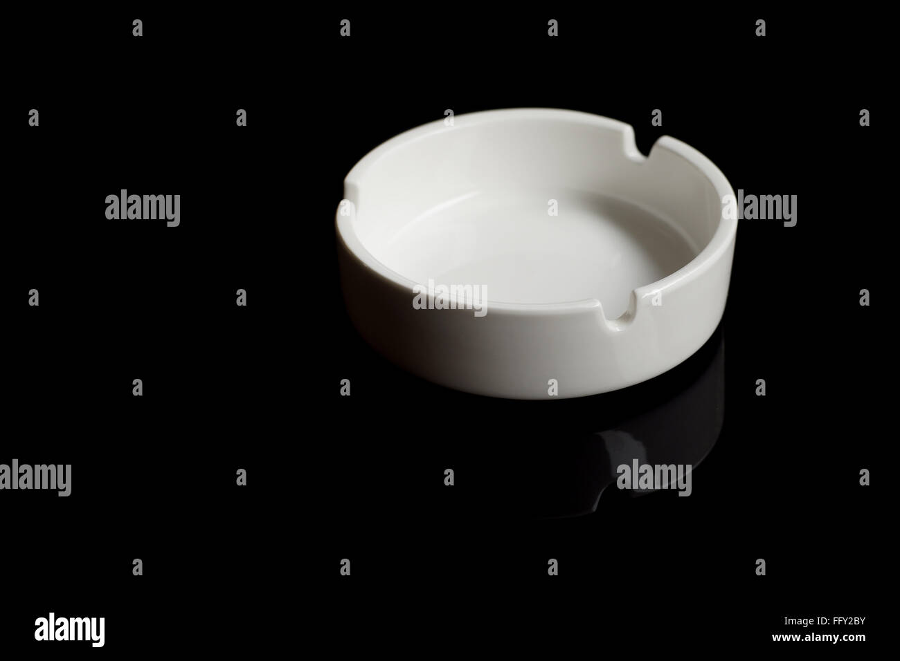 empty white ashtray isolated black background Stock Photo - Alamy