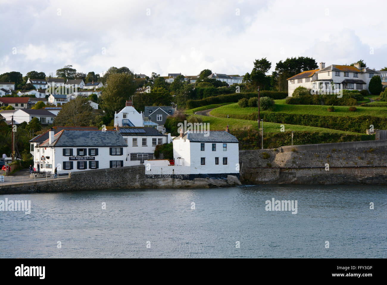 Portmellon in Cornwall, England. View across water to the Rising Sun ...