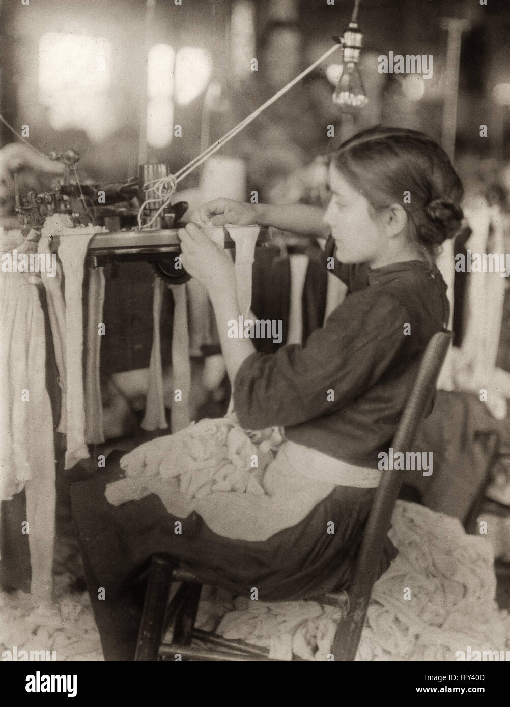 HINE: CHILD LABOR, 1913. /nA young worker using textile machinery at ...