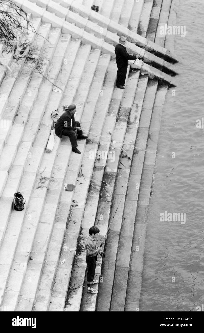BUDAPEST: FISHING. /nTwo men and a boy fishing from a staircase on the ...