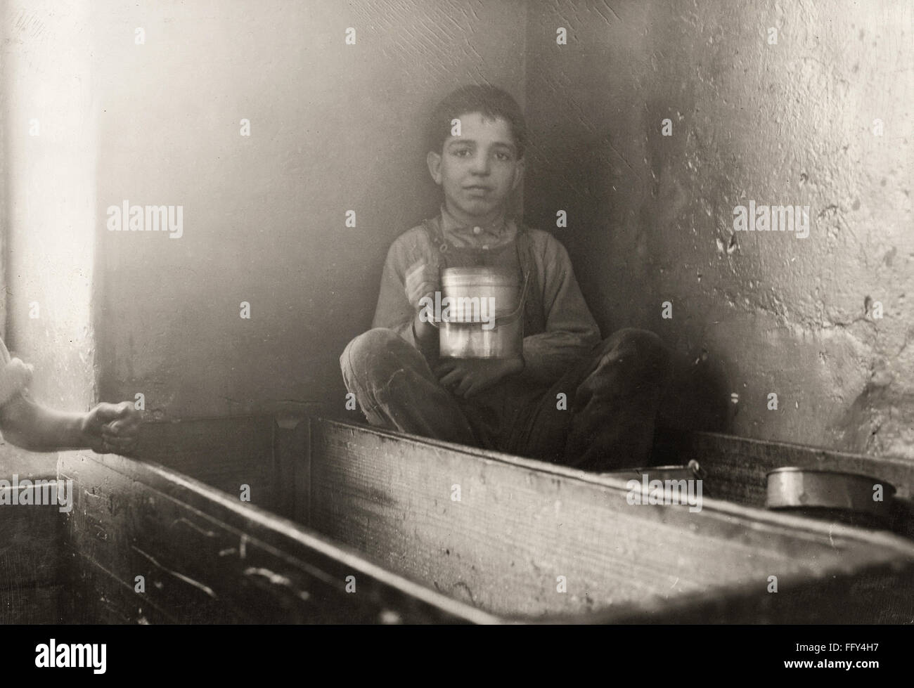 HINE: CHILD LABOR, 1912. /nA young textile mill worker eating his lunch ...