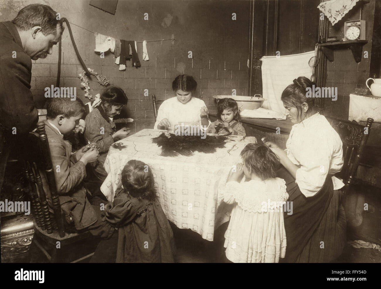 HINE: HOME INDUSTRY, 1911. /nA family making feathers late at night as ...