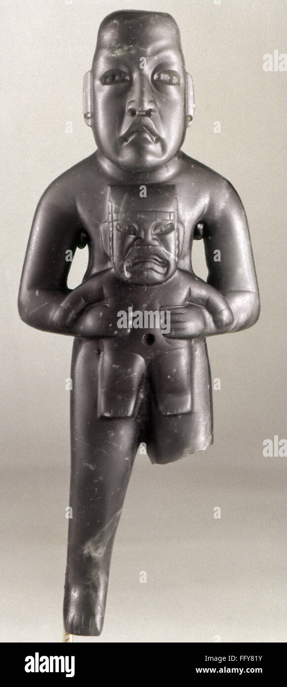 MEXICO: OLMEC FIGURE. /nOlmec jadeite figure holding a baby jaguar ...