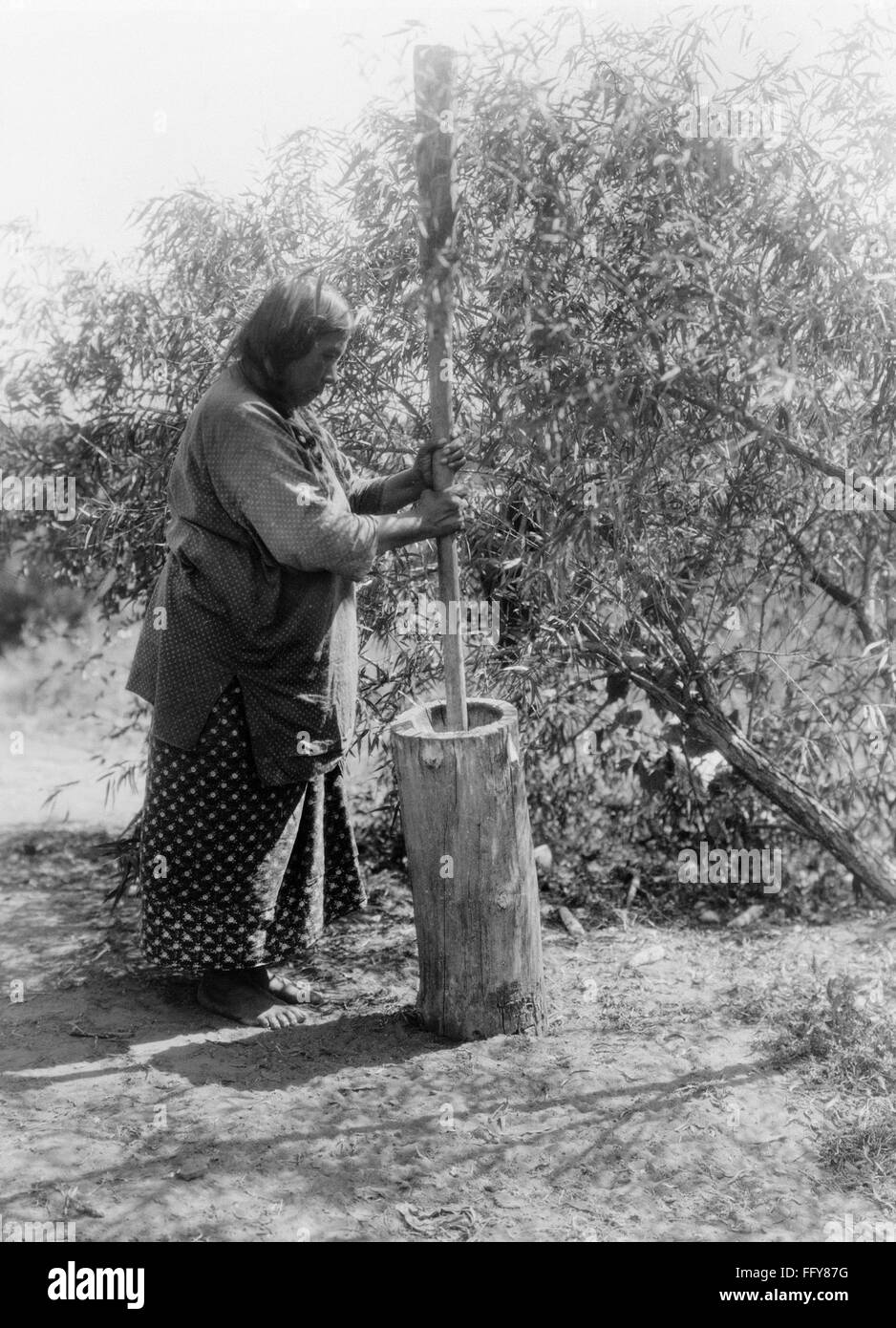 CURTIS: WICHITA WOMAN. /nA Wichita Native American woman using a large ...