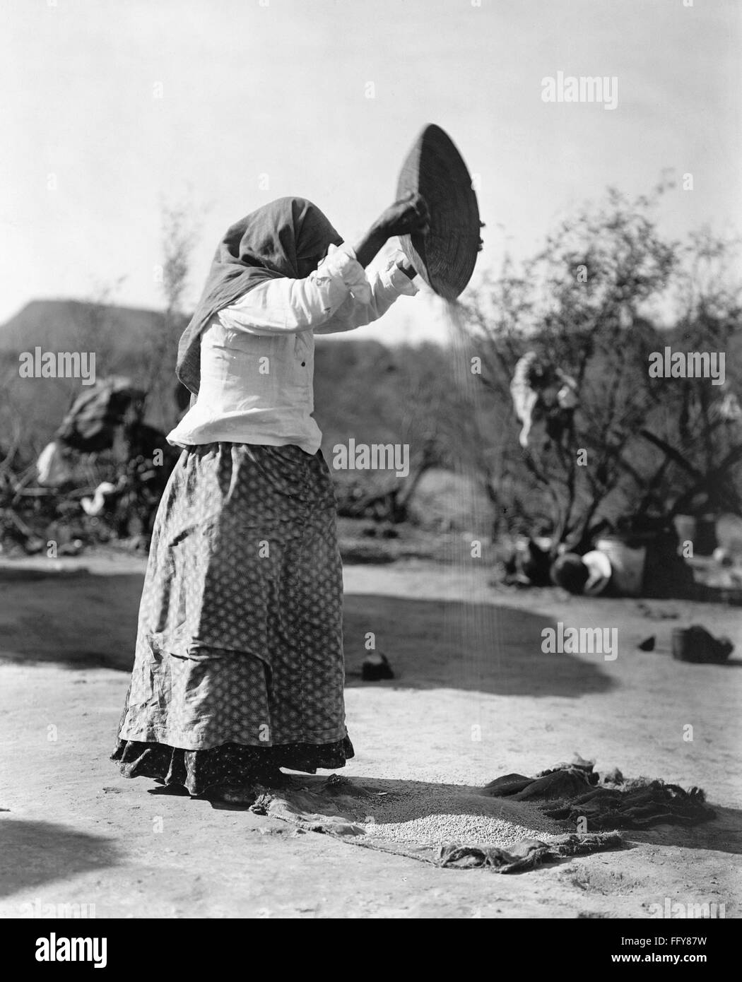 CURTIS: PAPAGO WOMAN, c1907. /nA Papago Native American woman winnowing ...