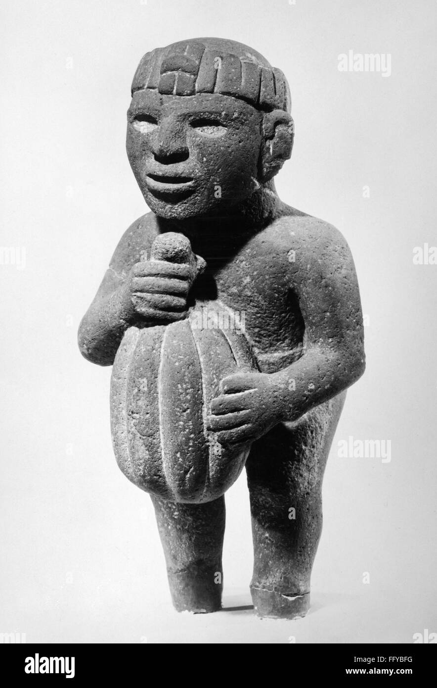 MEXICO: AZTEC FIGURE. /nAztec stone standing figure of a man carrying a ...