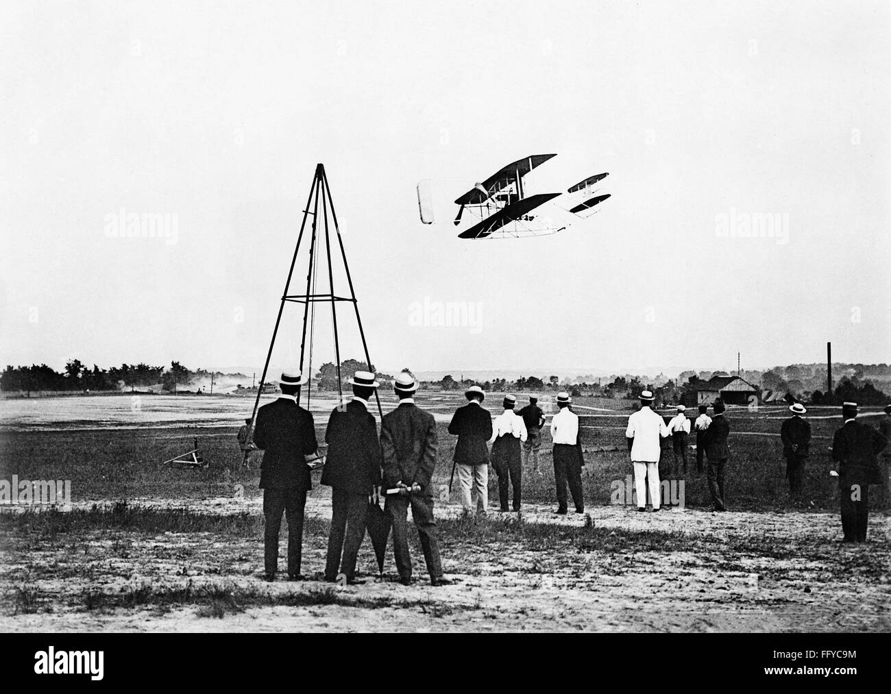 EARLY AIRPLANE, 1909. /nMen watching the flight of a biplane at Fort ...