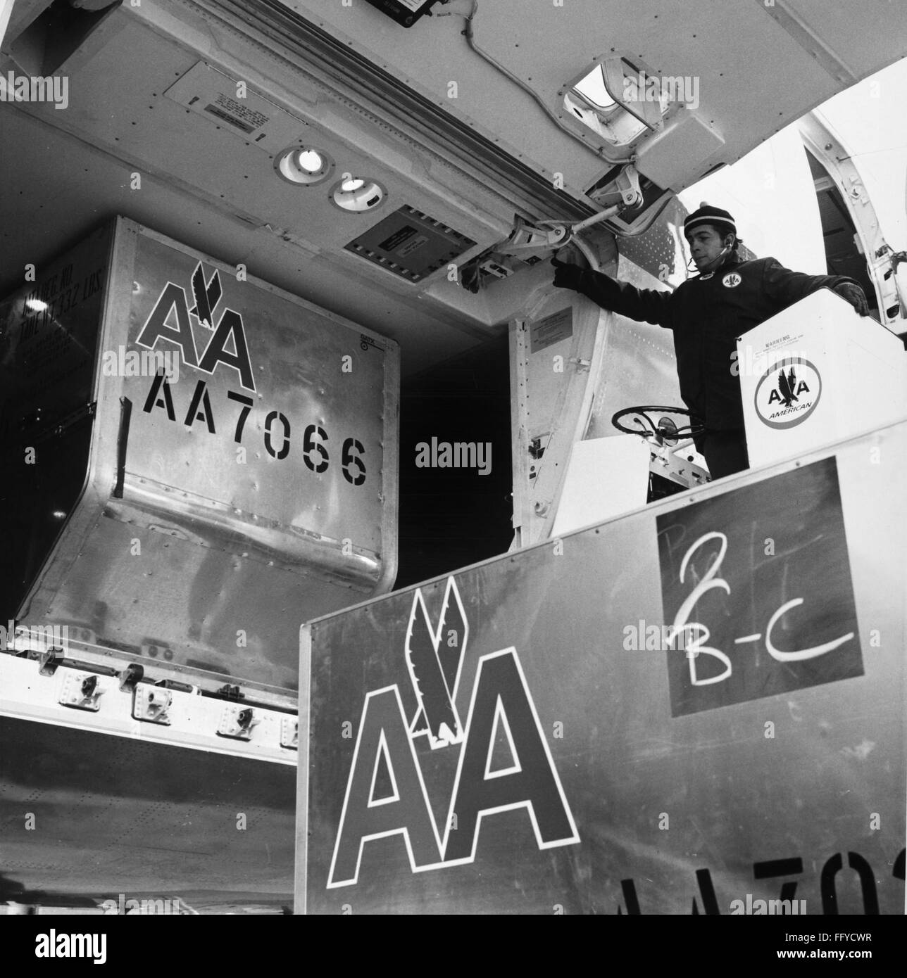 AMERICAN AIRLINES CARGO. /nA man loading cargo onto a Boeing 747 ...