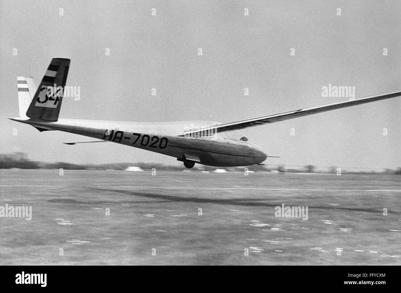 GLIDER COMPETITION. /nA single-seat glider in flight during a ...